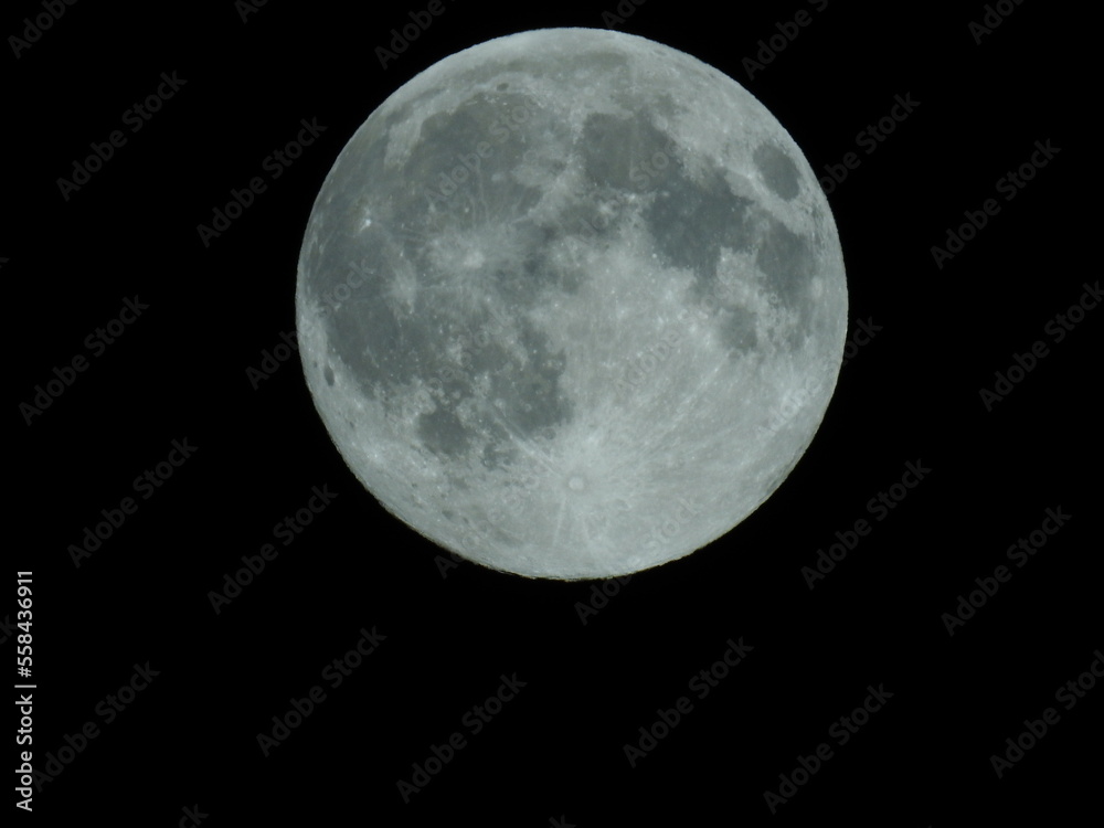 Telescopic view of a full moon. Full moon shot showing details of the ...