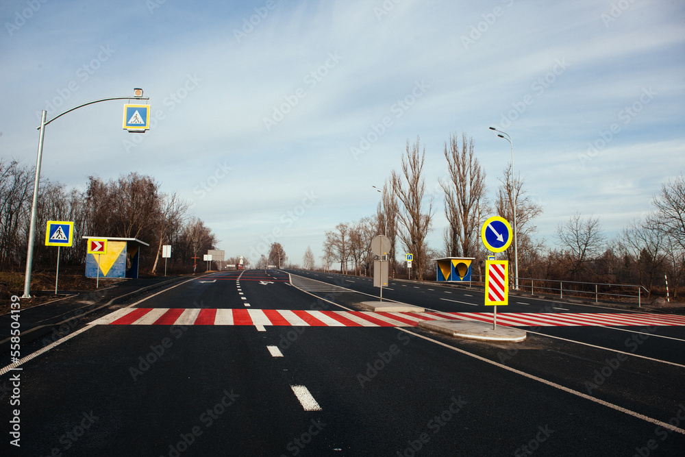 New asphalt road with markings and road signs in the sun's rays Stock ...