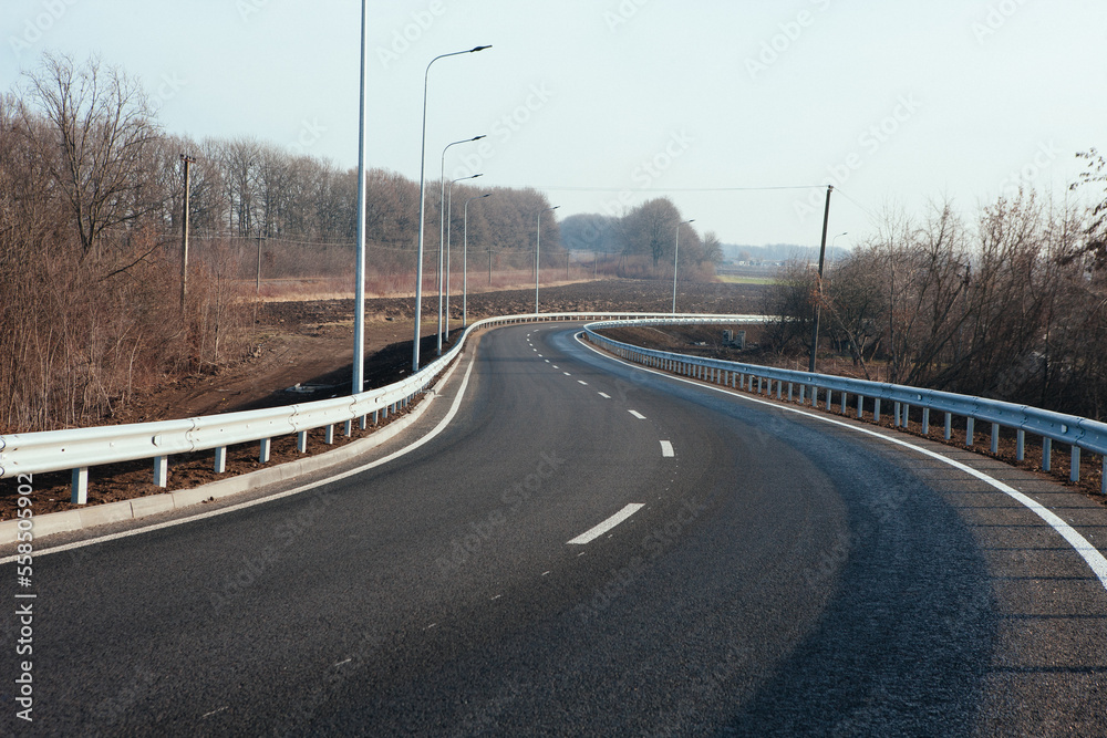 New asphalt road with markings and road signs in the sun's rays Stock ...