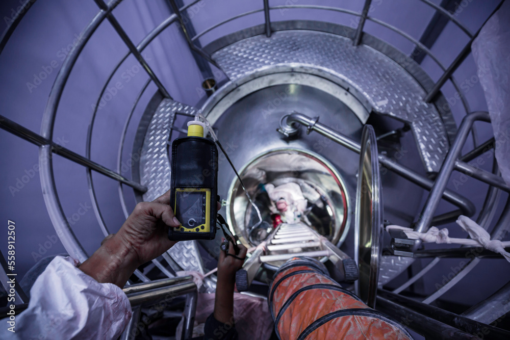 Worker hand holding gas detector inspection safety gas testing at front ...