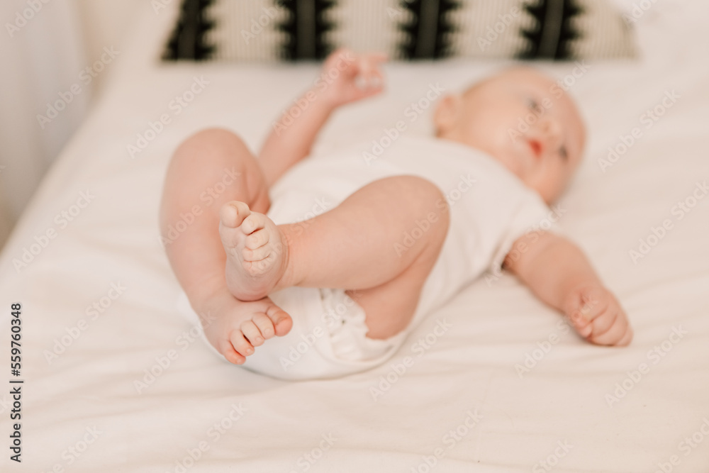 Little boy funny cute child legs, baby lying on bed, ready for a diaper ...
