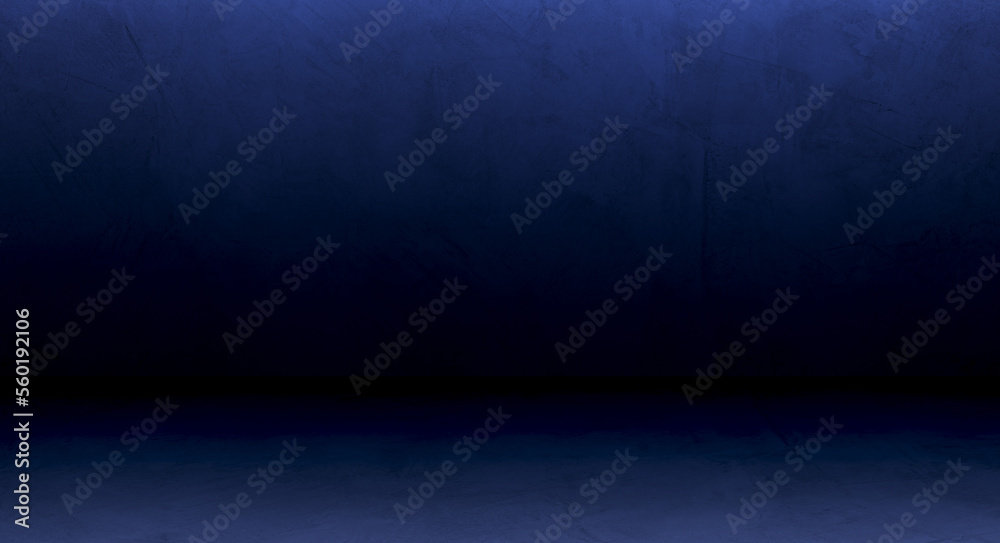Dark blue wall studio background with soft light and free space for ...