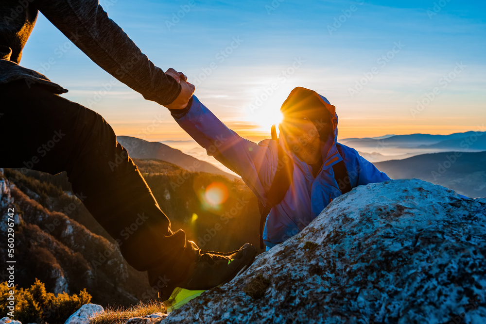 Hiking team people helping each other friend giving a helping hand ...