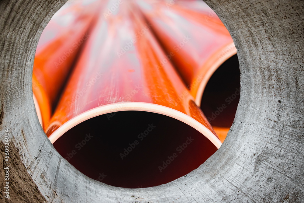 Orange sewer pipes at the construction site. Preparation for the ...