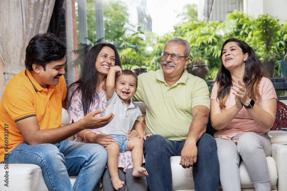 Portrait of Happy indian joint family sitting together at home. Asian ...