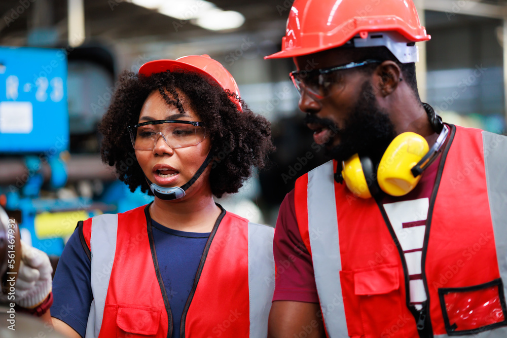 Black Woman worker wearing safety goggles control lathe machine to ...