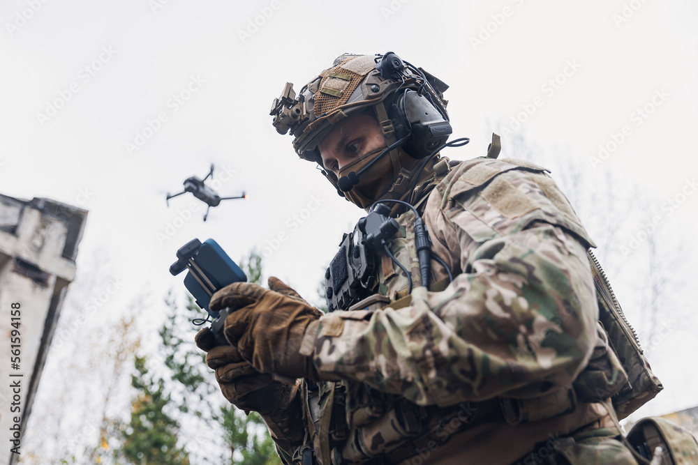 Military soldier controls drone for reconnaissance operation of enemy ...