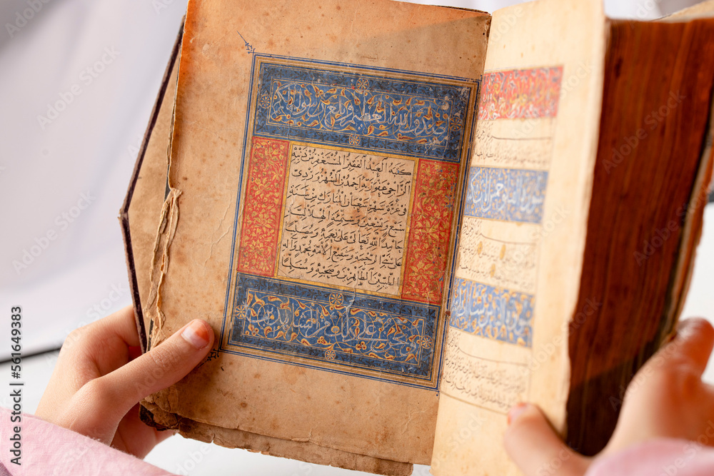 hand holding a rare book ,Muslim holy Quran Stock Photo | Adobe Stock