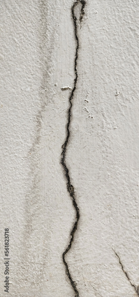 Vertical image of the crack in the cement wall or the corridor floor ...
