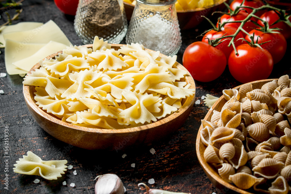 Different types of raw paste in bowls with garlic, tomatoes and spices ...