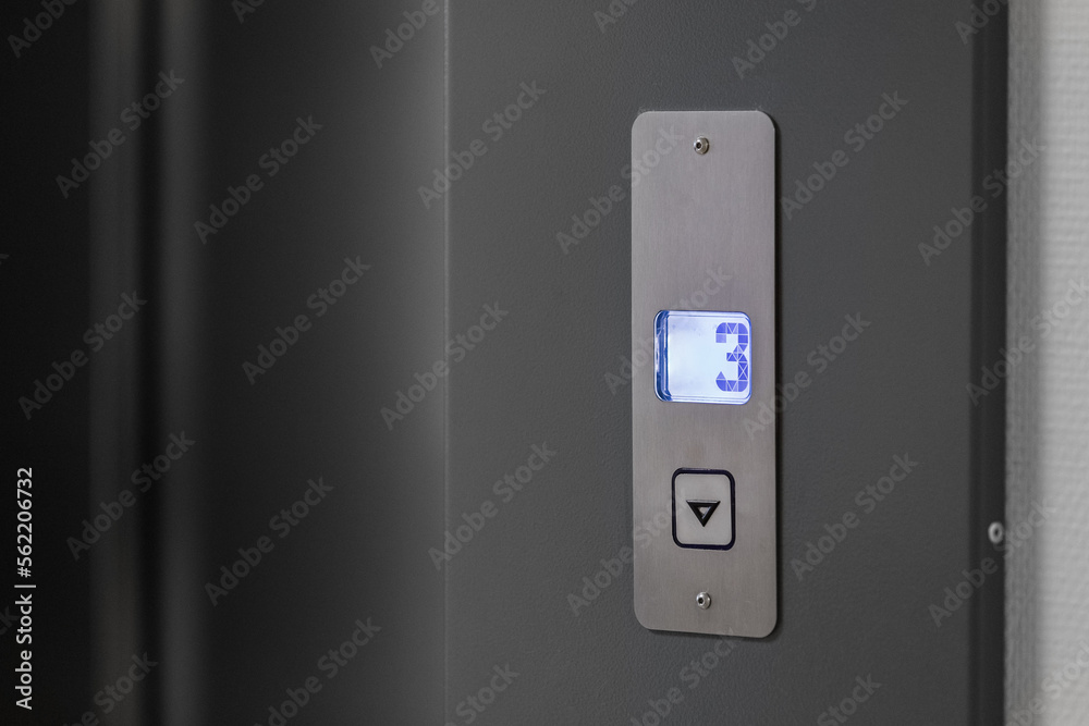 Metal panel with an elevator call button and an indicator of the floor ...