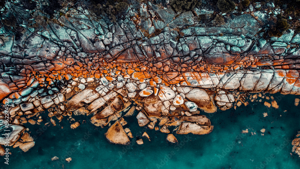Drone Aerial of Orange Lichen Covered Boulders at Bay of Fires ...