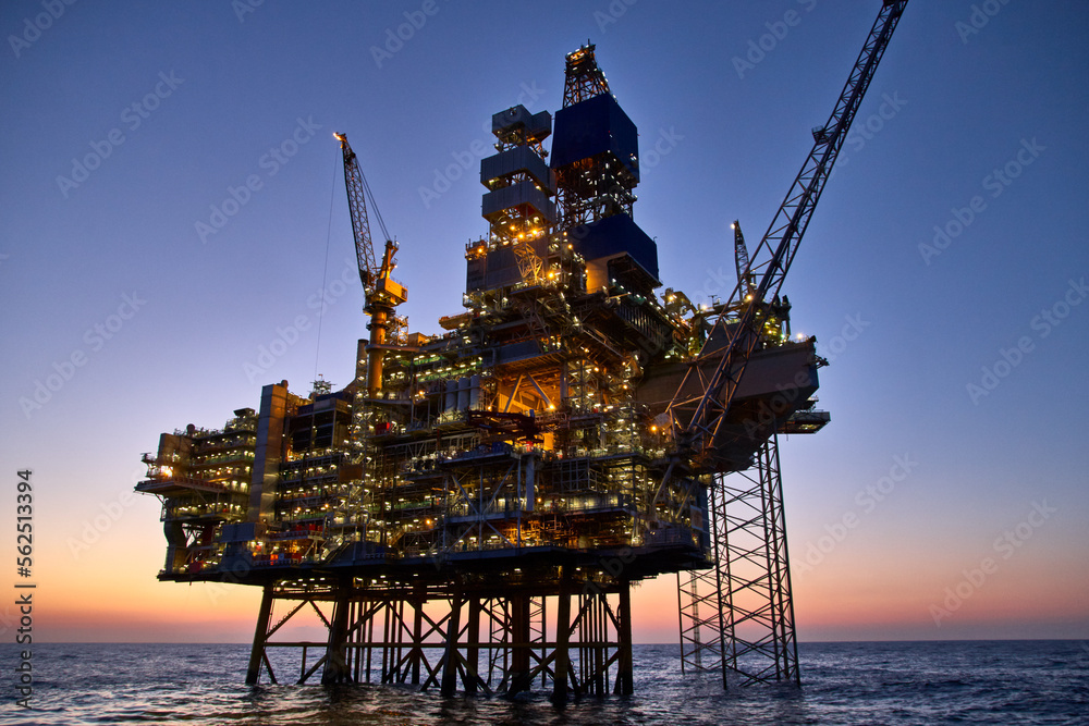 Offshore oil and gas platform in the sea at sunset. Jack up rig crude ...
