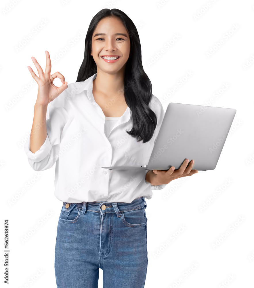 Cheerful beautiful Asian woman holding laptop and shows ok sign on ...