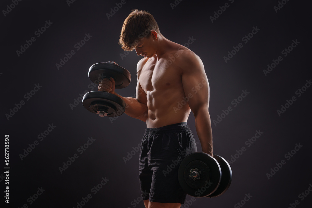 Young handsome sportsman bodybuilder weightlifter with an ideal body ...