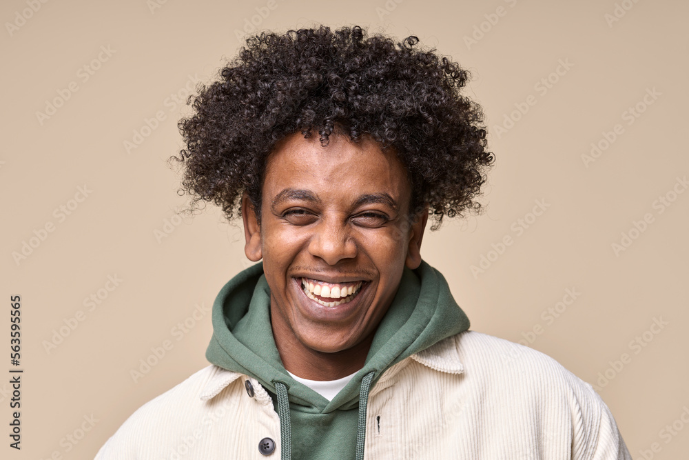 Happy cheerful young African American gen z guy isolated on beige ...