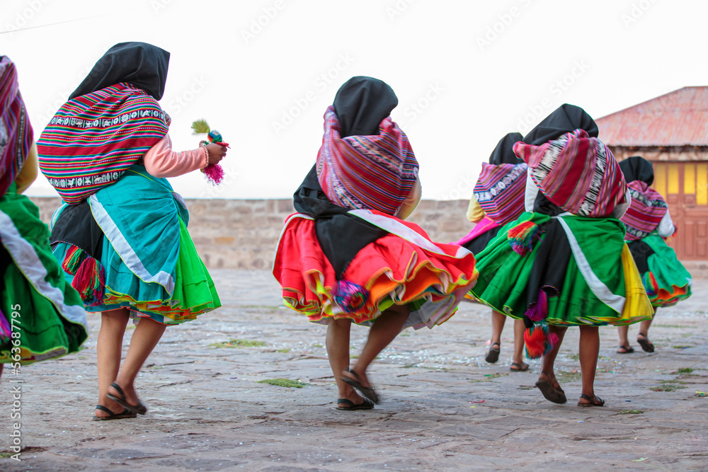 Group of unrecognizable Peruvian women dancing in the town square in ...