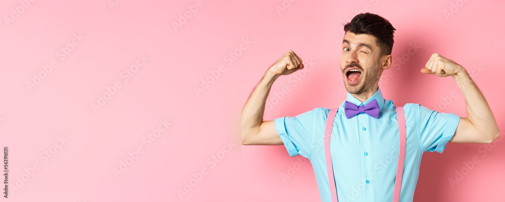 Strong and funny guy with french moustache, flexing biceps and winking ...