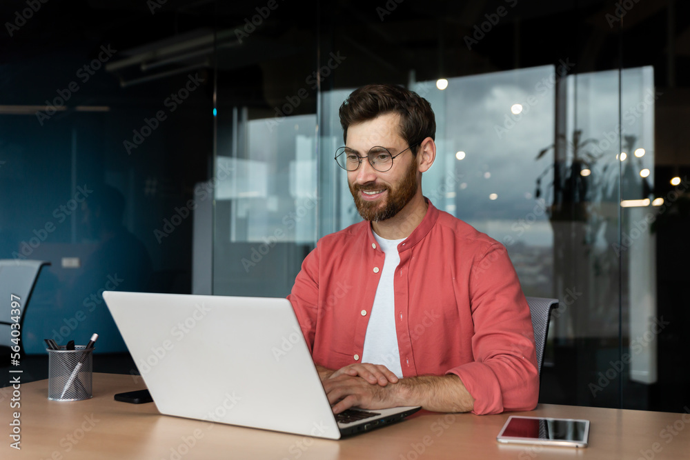 Successful smiling man working inside office with laptop, businessman ...