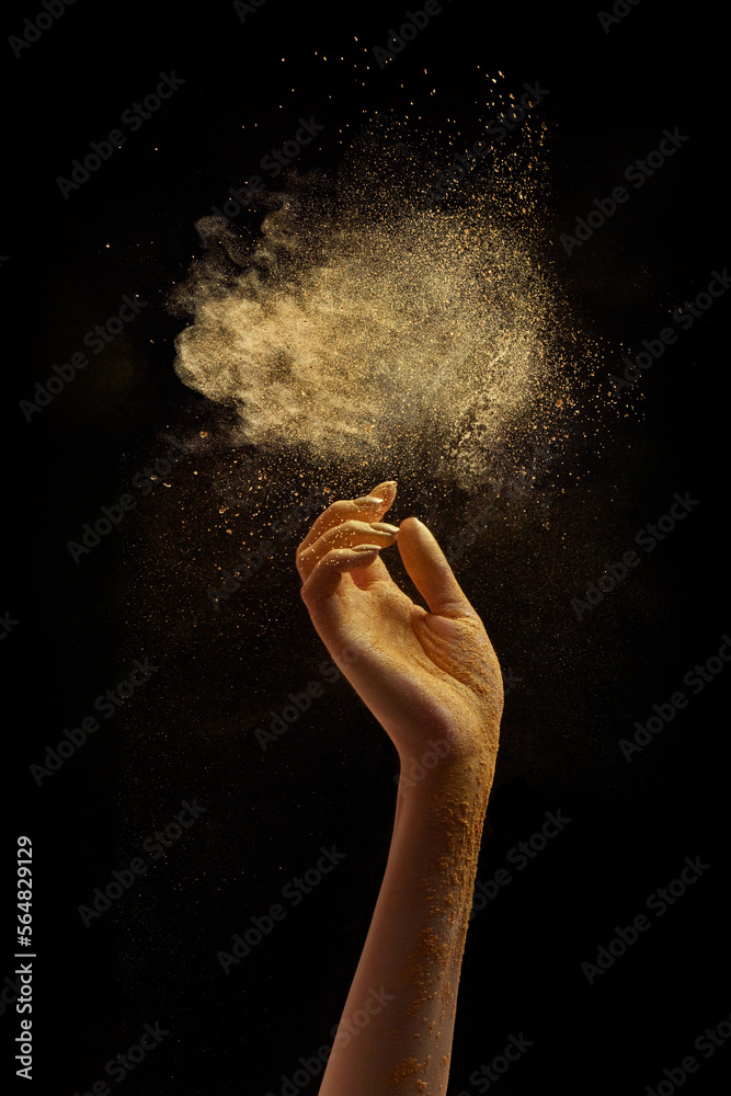 Female arm and yellow dust cloud. Stock Photo | Adobe Stock