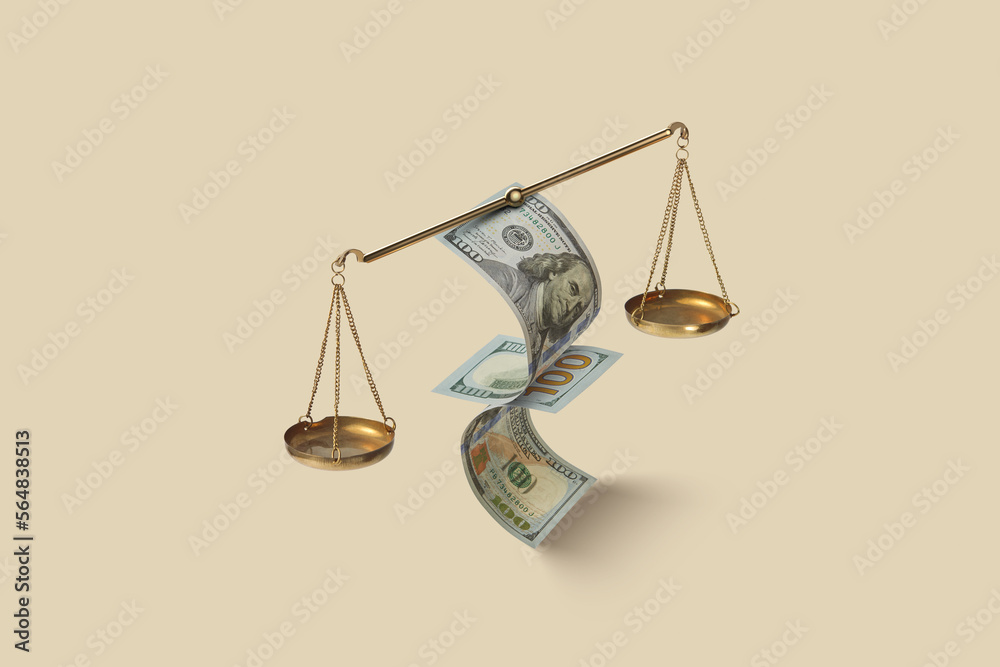 Golden scale balancing on two 100 dollar bill. Stock Photo | Adobe Stock
