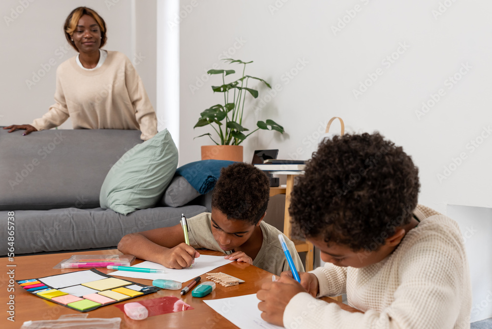 Mom checking sons doing homework Stock Photo | Adobe Stock