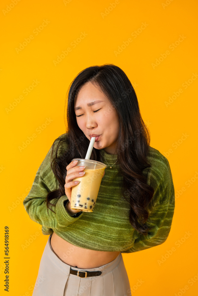 Content Asian woman drinking bubble tea Stock Photo | Adobe Stock