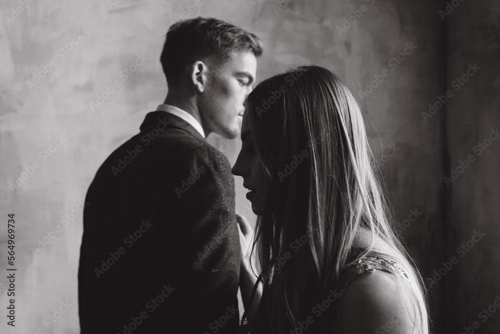 Beautiful stylish and fashionable couple in a suit, dress and coat with ...