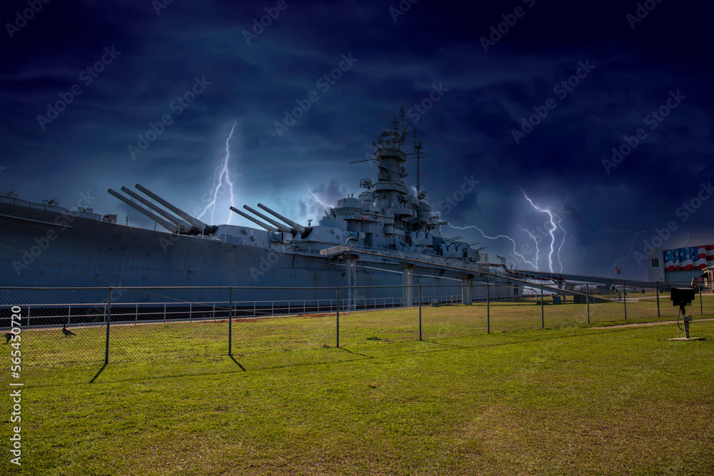 The USS Alabama Battleship docked in Mobile Bay surrounded by lush ...