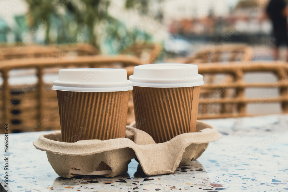 Two paper cups with lid for tea to go. Coffee take away on the table. Take