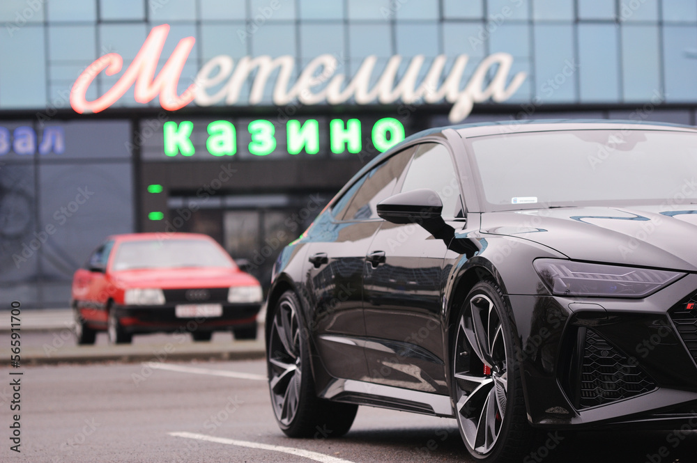 Belarus, Minsk - 24.01.2023: Black premium car Audi RS 7 Sportback and Audi 100 are parked on ...