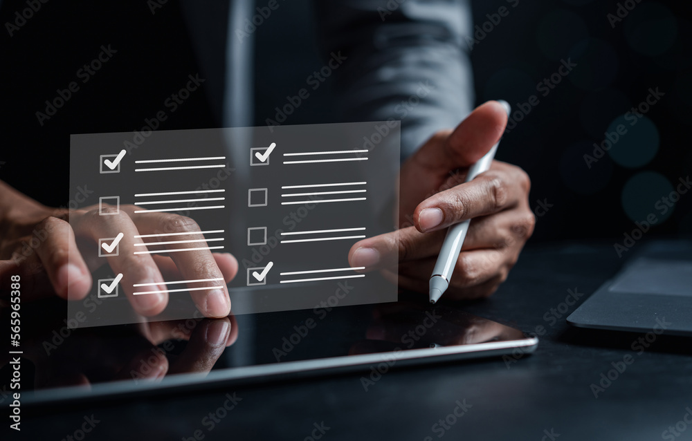 Businessman tick mark an assessment, questionnaire, evaluation, online ...