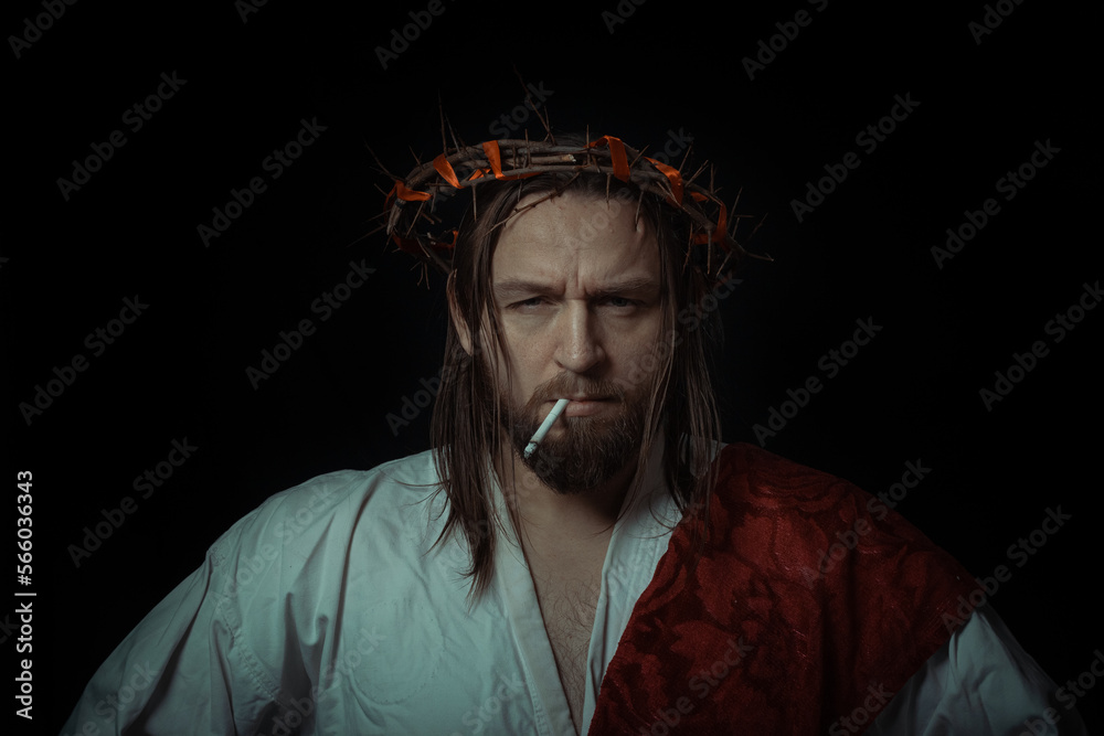 Foto de Stock Jesus Christ smokes a cigarette wearing a crown of thorns ...