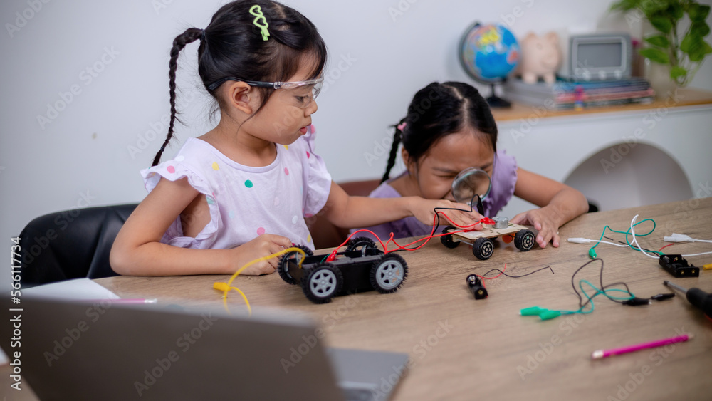 Asian students learn at home by coding robot cars and electronic board ...