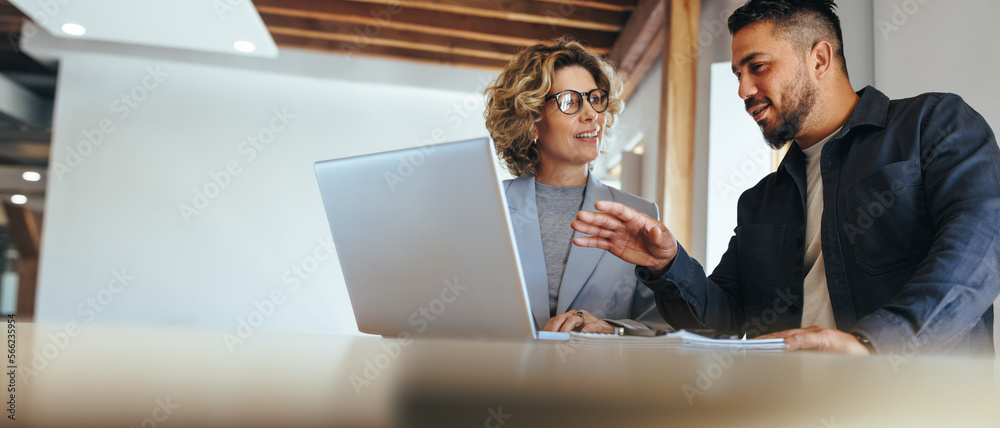 Business man having a discussion with his colleague in an office Stock ...