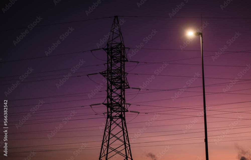 Electrical power grid and sunset sky. Electric tower and lines. High ...