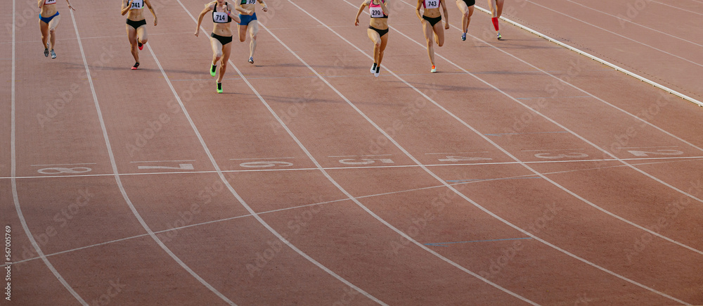 group female athletes run finish line at stadium Stock Photo | Adobe Stock