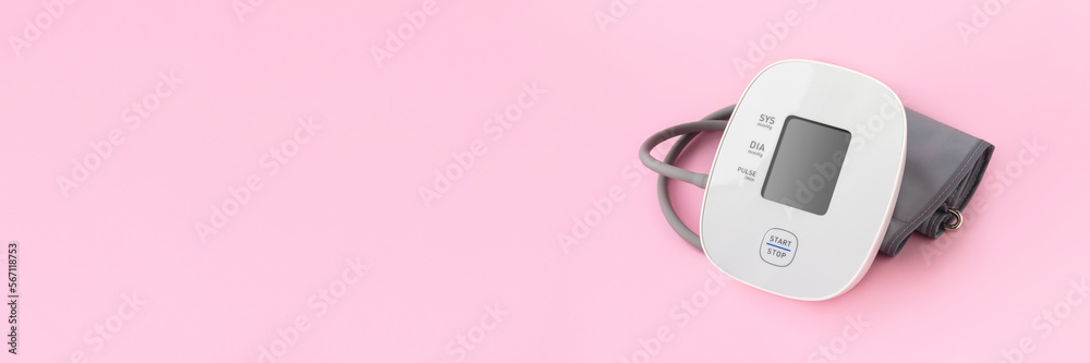 Automatic blood pressure monitor on pink background banner. Medical ...