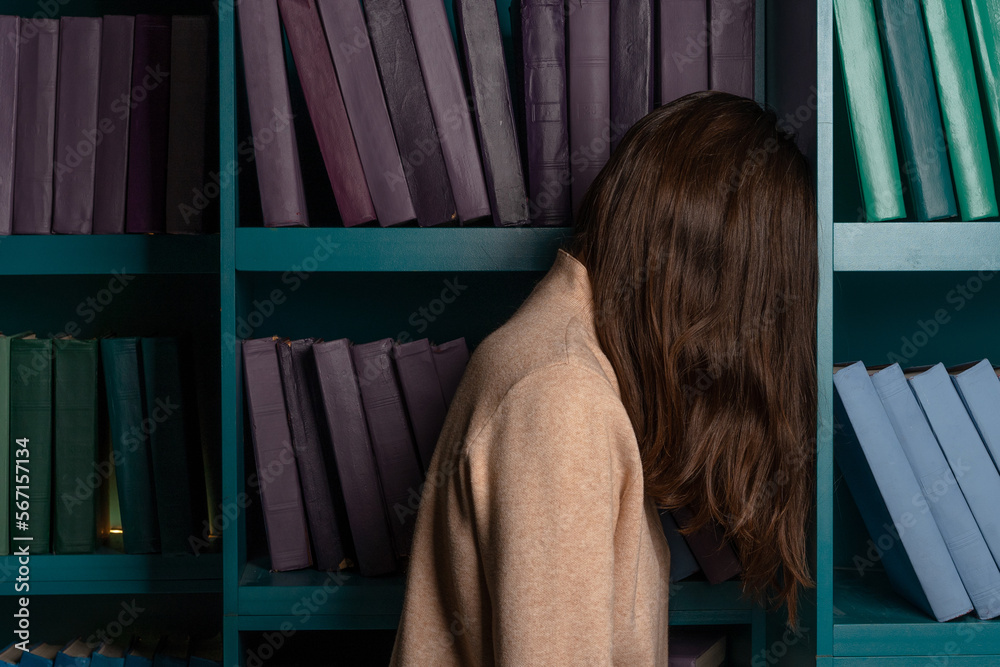 Sad student on the background of bookshelves. Exam stress. academic ...