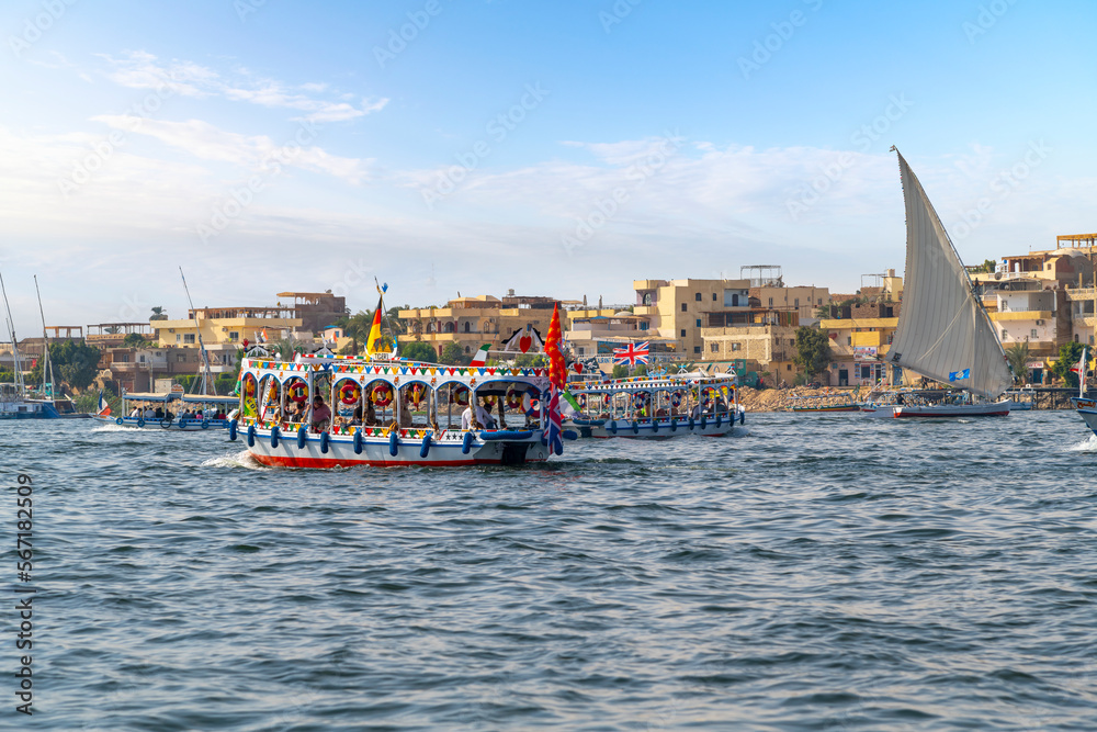 Colorful touristic river cruise boats and feluccas on the African Nile ...