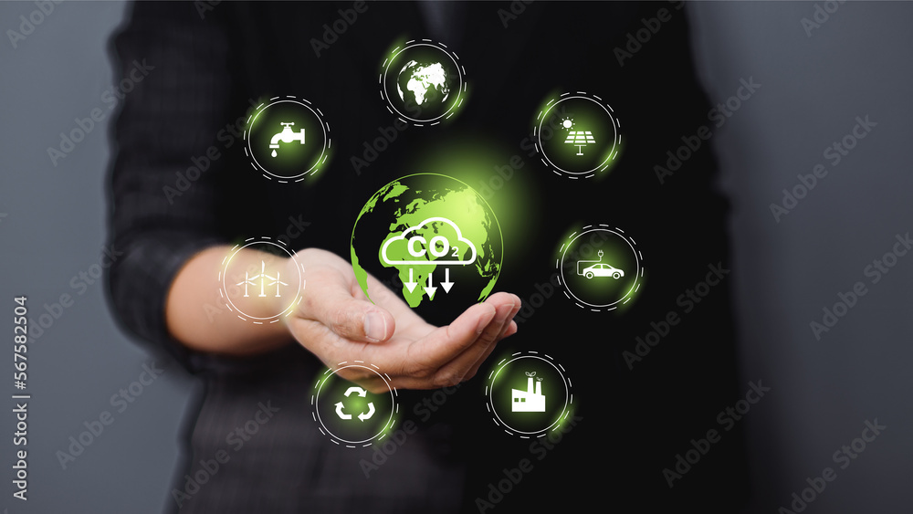 Foto Hand holding virtual Global with CO2 reducing icon for concept of decrease carbon dioxide ...