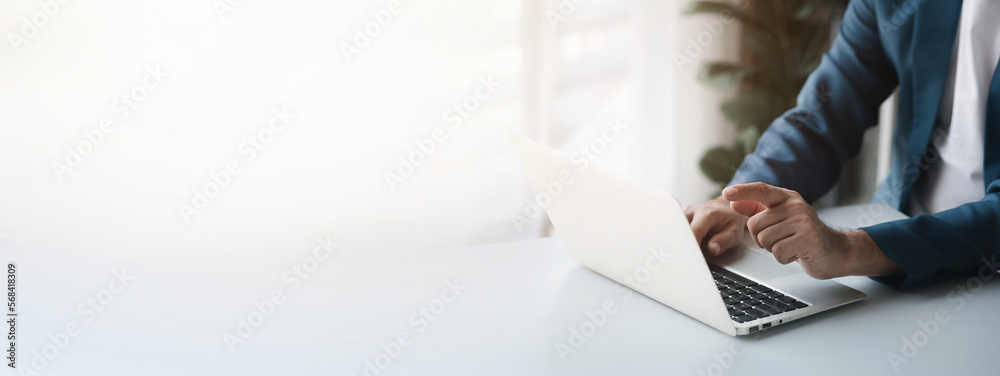 Person typing on laptop keyboard and pointing at screen, businessman ...