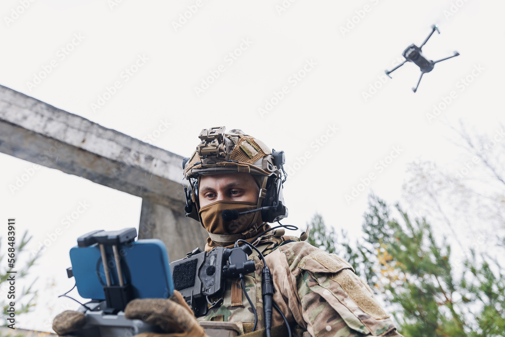 Military soldier controls drone for reconnaissance operation of enemy ...