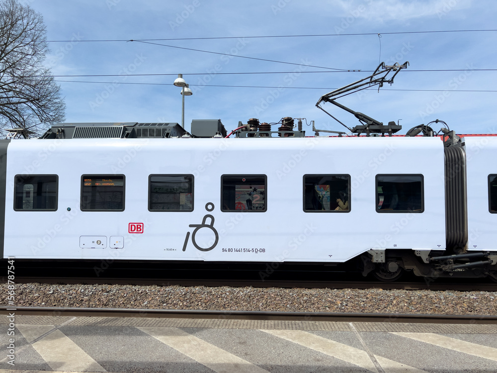 White regional train of the Deutsche Bahn with a large disabled sign ...