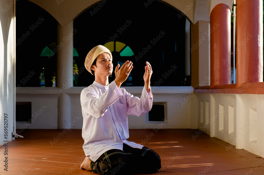 Religious muslim islam man in white session lift two hand for praying ...