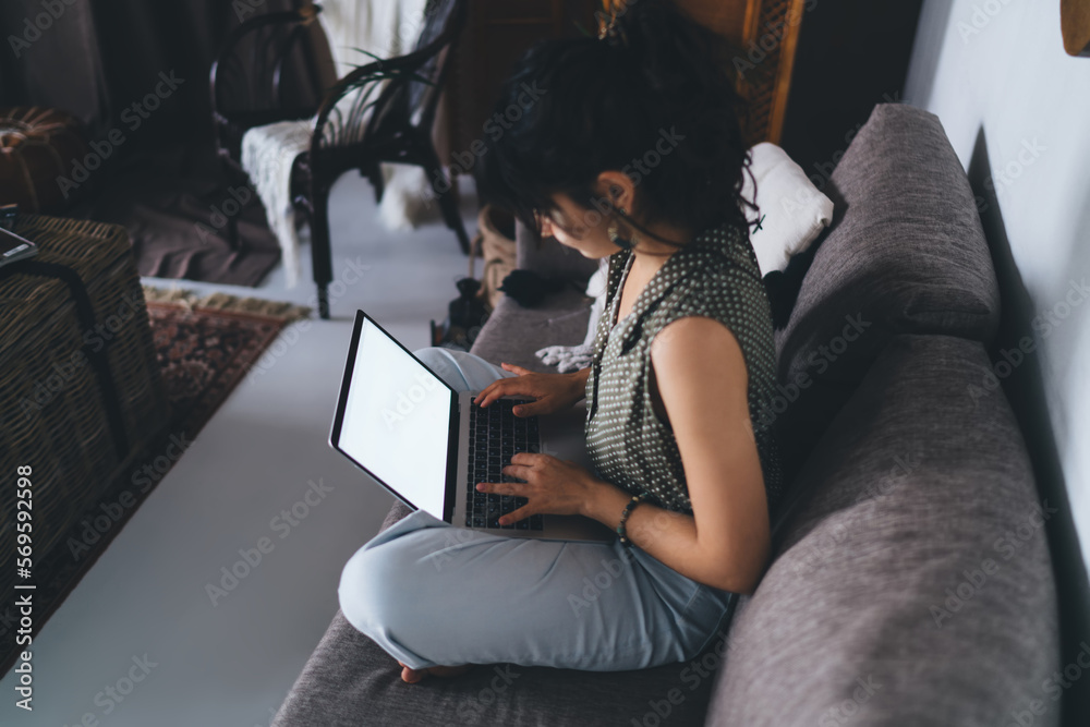 Young female sitting front open laptop computer with blank mock up ...