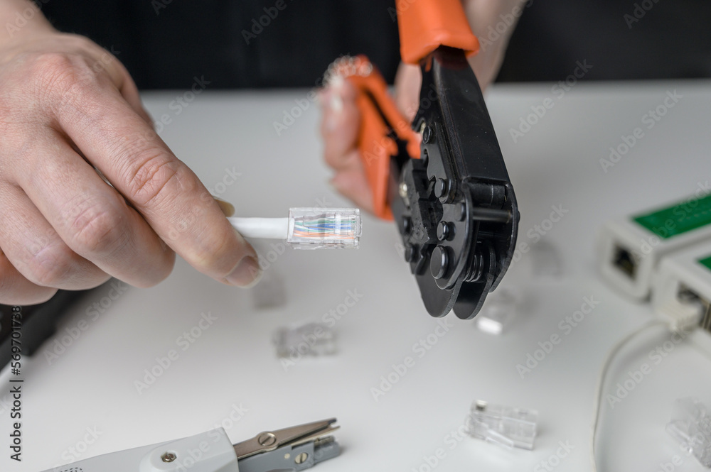 Photo Stock cable twisting tool UTP Cat 5 ethernet twisted pair, connecting procedure UTP cable ...