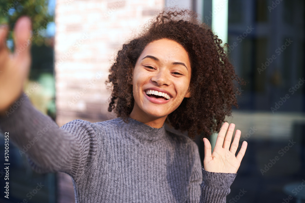 Attractive African American woman smiling a toothy smile, waving hello ...
