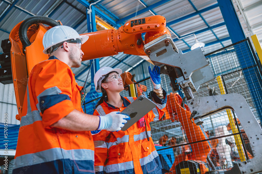 engineer teamwork working in automation factory service program robotic ...