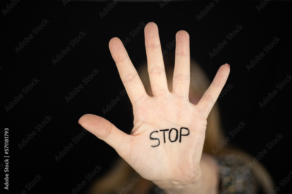 Woman showing hand stop sign with word STOP written to campaign against ...